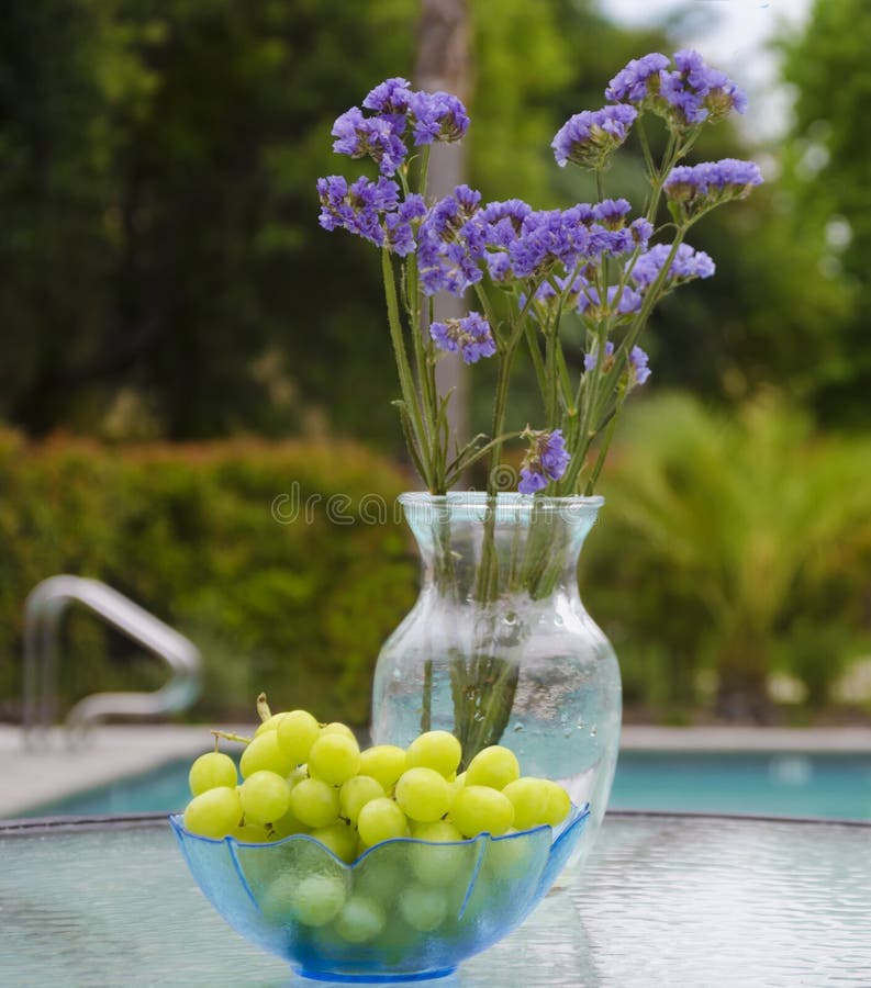 Vase with Flowers and Grapes by the Pool Stock Image - Image of pool ...