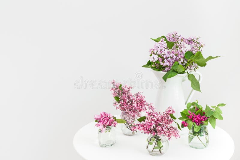 Vases with Blooming Spring Flowers on a Round Table Stock Image - Image ...