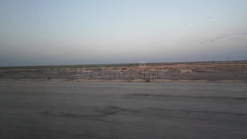 A Vast, Barren Desert Landscape with a Flat Horizon Under a Clear Sky ...