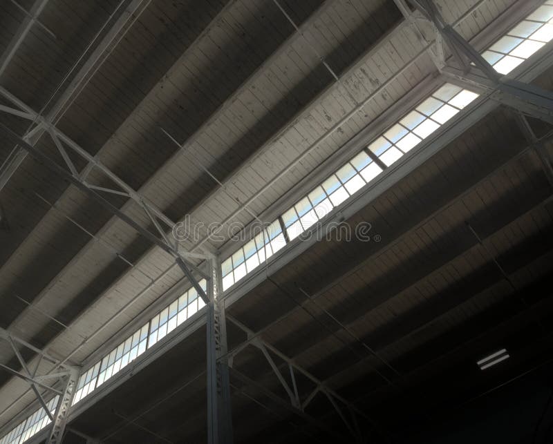 Vast Ceiling of a Massive Industrial Warehouse Illuminated by Rows of ...