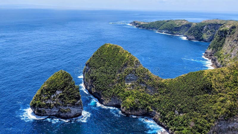 Vast Cliffs and Lush Greenery Rise Dramatically from the Deep Blue ...