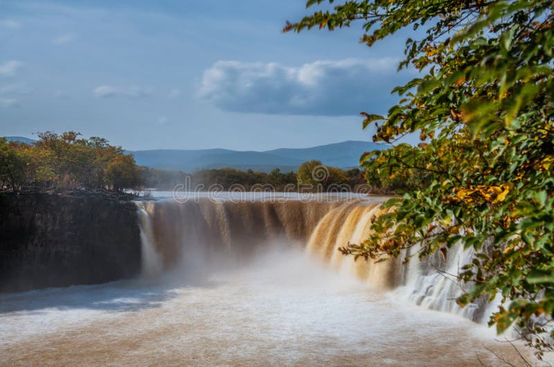 A Large Waterfall is Shown in the Middle of a Forest Stock Image ...