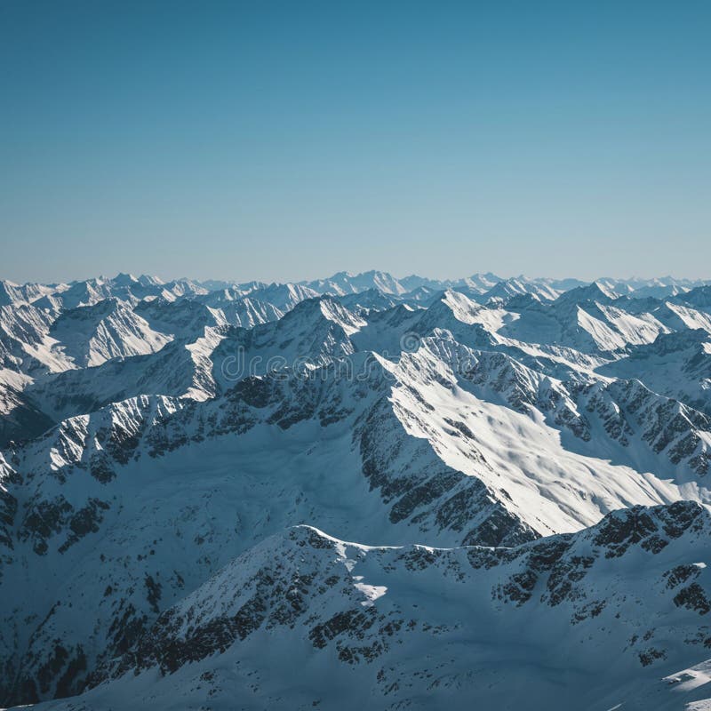 A Vast Mountain Range with Rugged, Snow-covered Peaks Extends into the ...