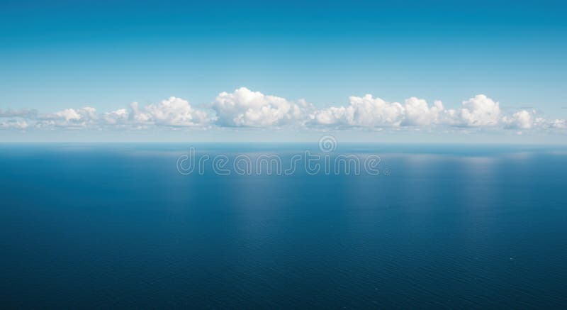 Vast Ocean View Under a Blue Sky with Puffy White Clouds Stock ...