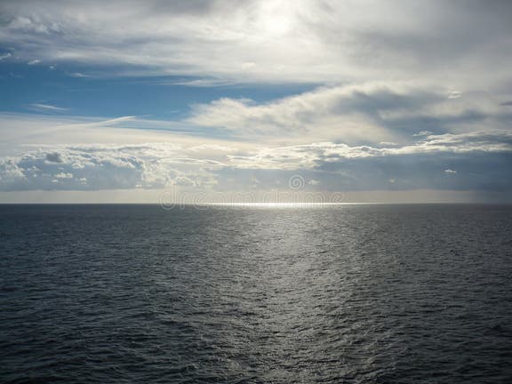 Vast Open Sea Under Dramatic Clouds with Sunlight Stock Image - Image ...
