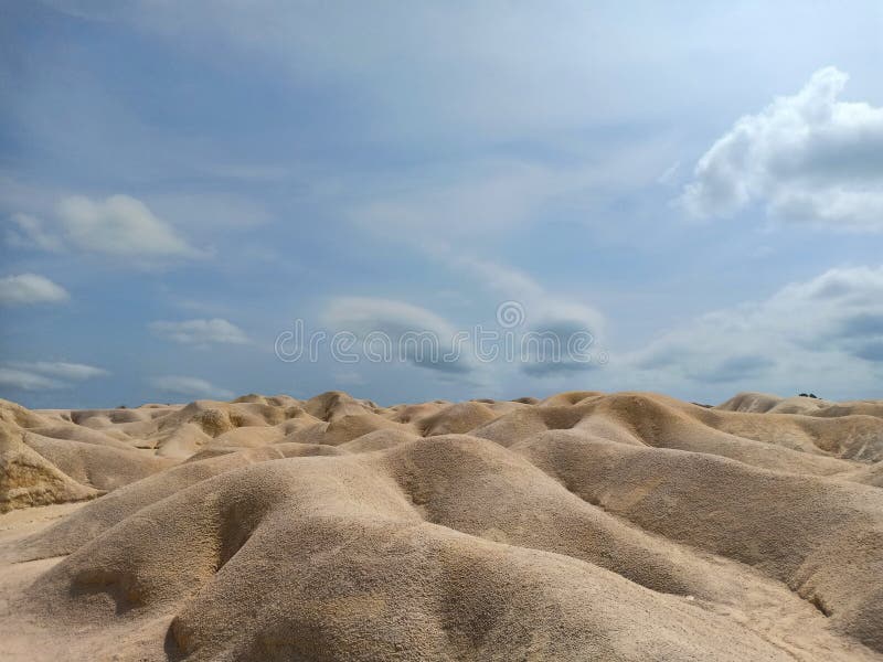A Vast Wavy Desert Under Bright Blue Sky with Some Clouds Stock Photo ...