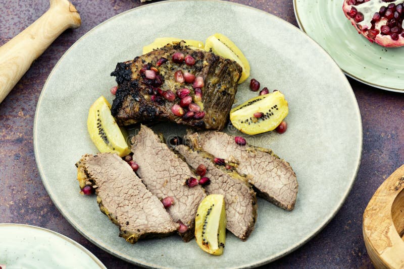 Veal Meat Roasted with Kiwi and Pomegranate Stock Photo - Image of ...