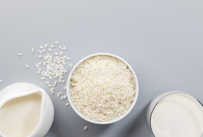 Vegan Rice Milk with Rice Grains on Gray Background. Copy Space, Top ...