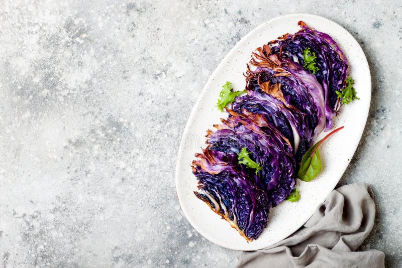 Vegan Roasted Red Cabbage Steaks on Grey Concrete Background. Top View ...