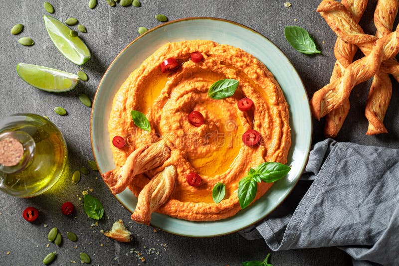Vegan Tomato Hummus with Olives, Basil and Breadsticks Stock Photo ...