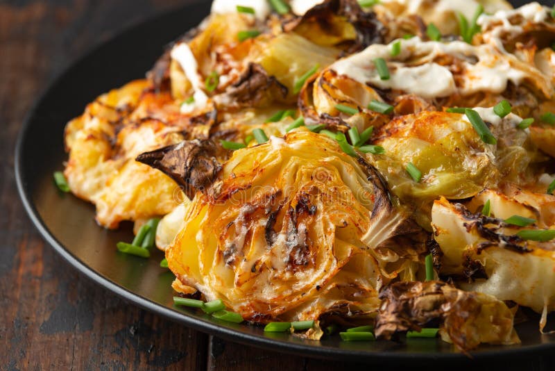 Vegan Vegetarian Roasted Cabbage Steaks on Black Plate Stock Photo ...