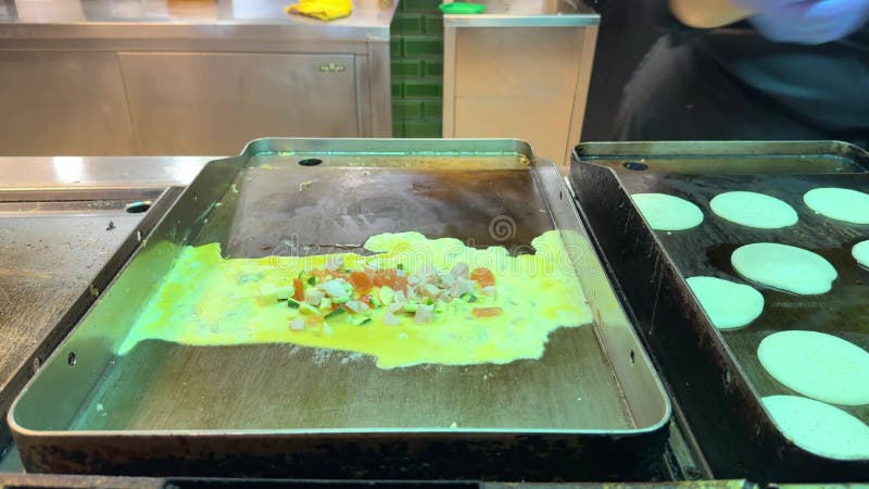 Vegetable Omelet Cooking on a Hot Griddle Next To Round Pancakes, Slow ...