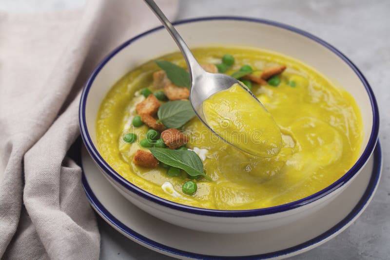 Vegetable Puree Soup with a Tablespoon with Crackers and Basil Stock ...