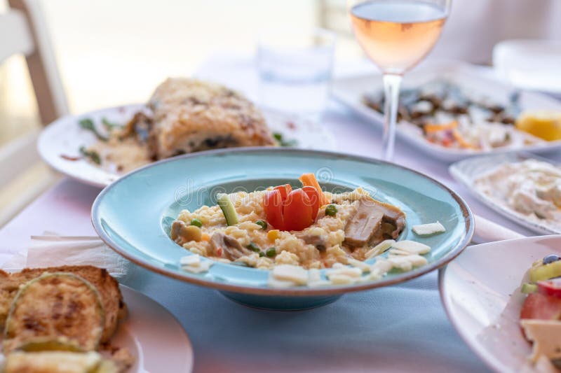 Vegetable Risotto Dish Served on Table Full of Food Stock Image - Image ...