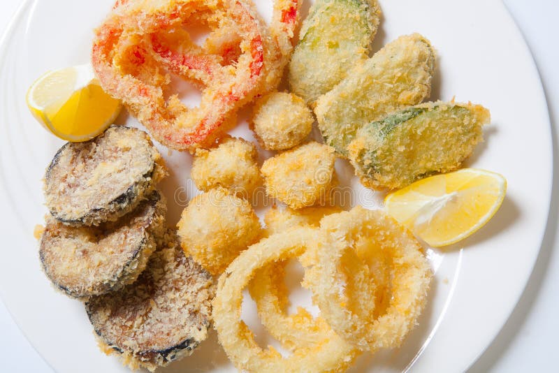 Vegetables in Batter. Onion Rings, Pepper Eggplant Zucchini and Lemon ...