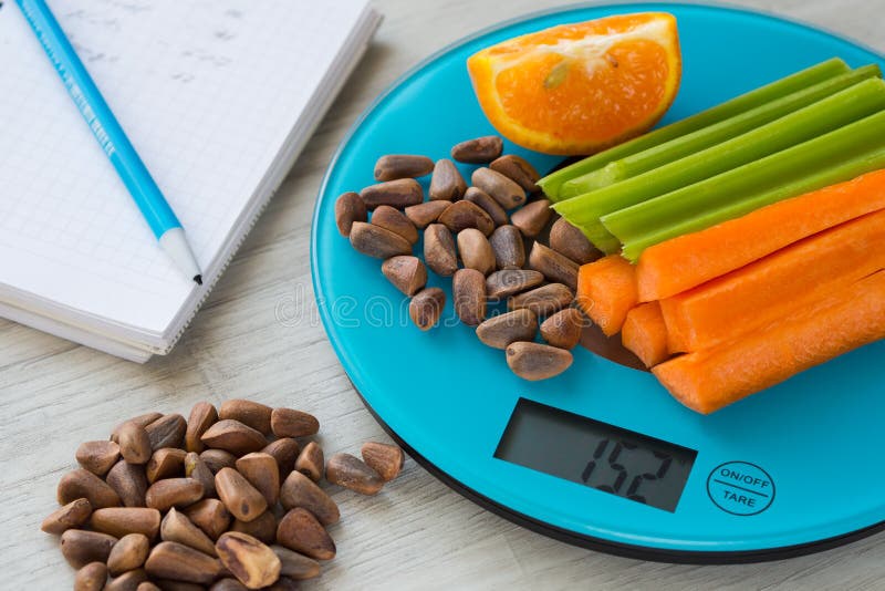 Vegetables and Nuts on the Scales. Calorie Counting Stock Photo - Image ...