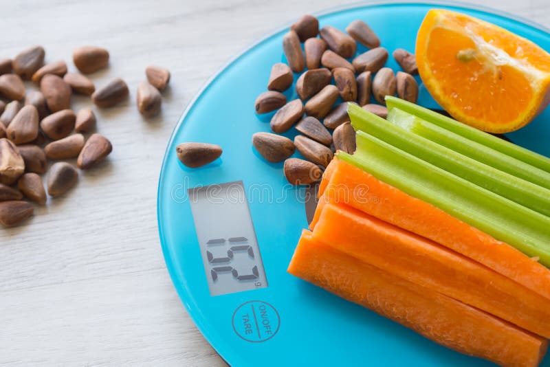 Vegetables and Nuts on the Scales. Calorie Counting Stock Image - Image ...