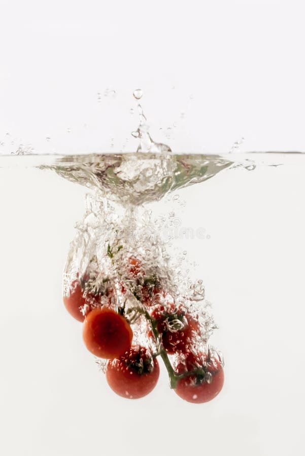 Tomatoes thrown in water stock photo. Image of action - 41330000