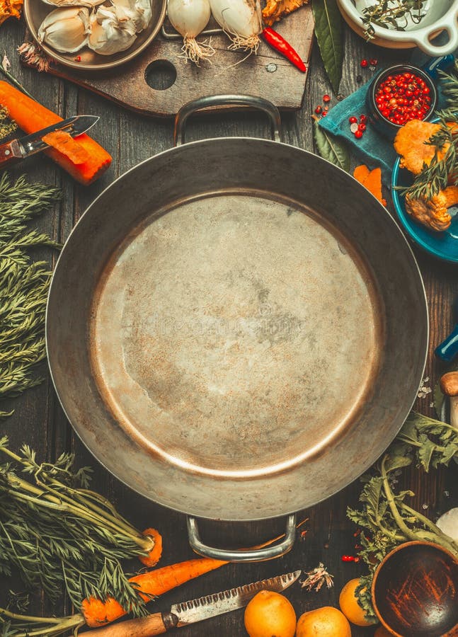 Vegetarian Cooking Ingredients Around Blank Aged Cooking Pot on Dark ...
