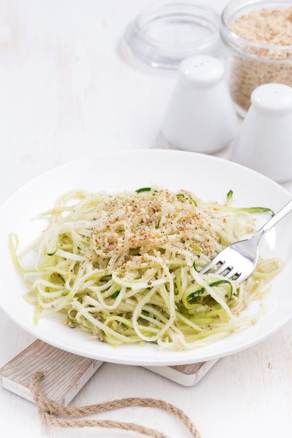 Vegetarian Pasta with Zucchini and Nuts on White Table, Vertical Stock ...