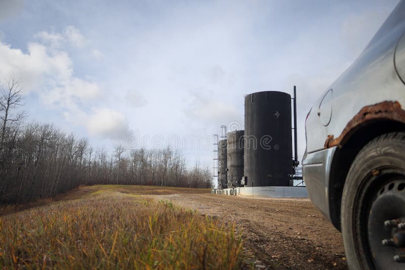 Vehicle Parked in Front of Bitumen Oil Storage Tanks on an Oil Lease ...