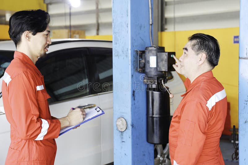 Vehicle Service Maintenance Handsome Men Checking Under Car in Garage ...