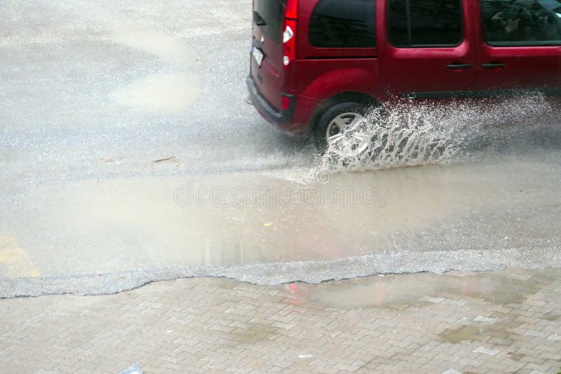 Vehicles Speeding through Puddles Splash Water Stock Image - Image of ...