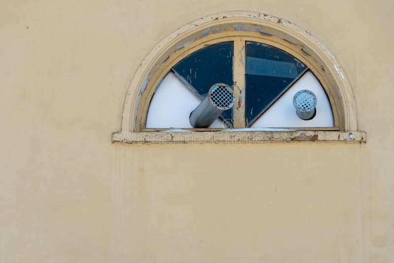 A Vent Pipe Protrudes from an Unusually Shaped Window. Ventilation of ...