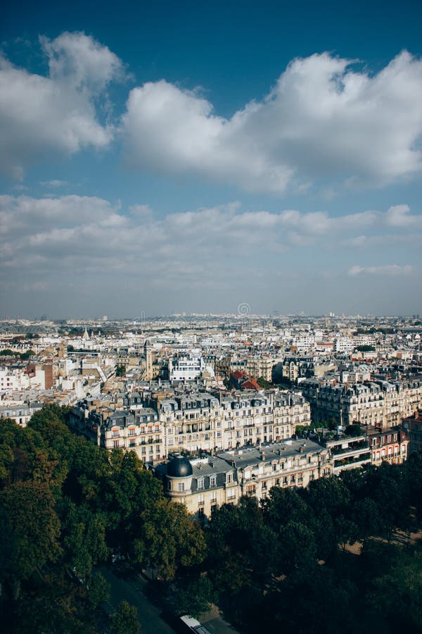 Vertical Aerial Shot of an Urban Area Surrounded by a Green Scenery ...
