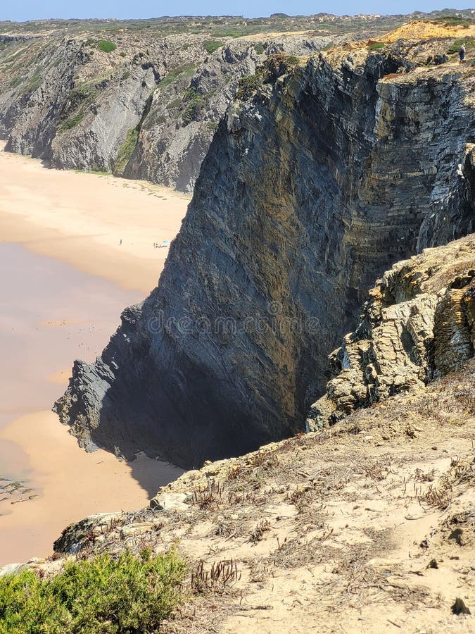 Vertical Aerial View of Rugged Steep Cliffs Overlooking the Sandy Beach ...