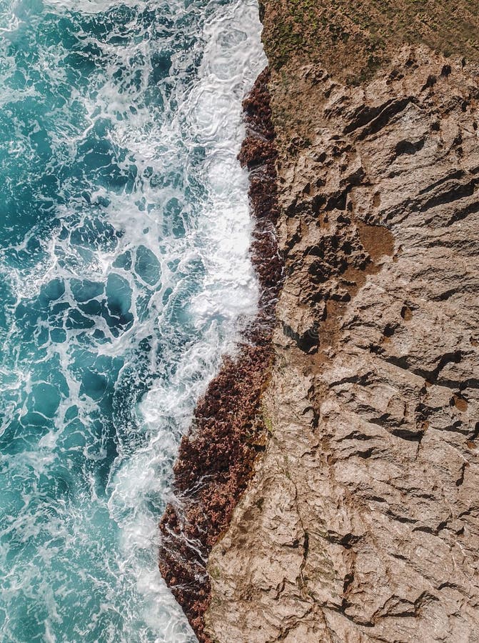 Vertical Aerial View of the Sea Waves Splashing Over the Rocks on the ...