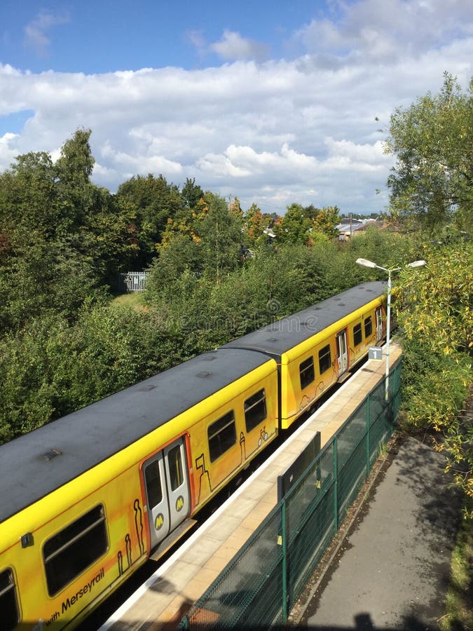 Vertical Aerial View of a Yellow Merseyrail Train on the Tracks through ...