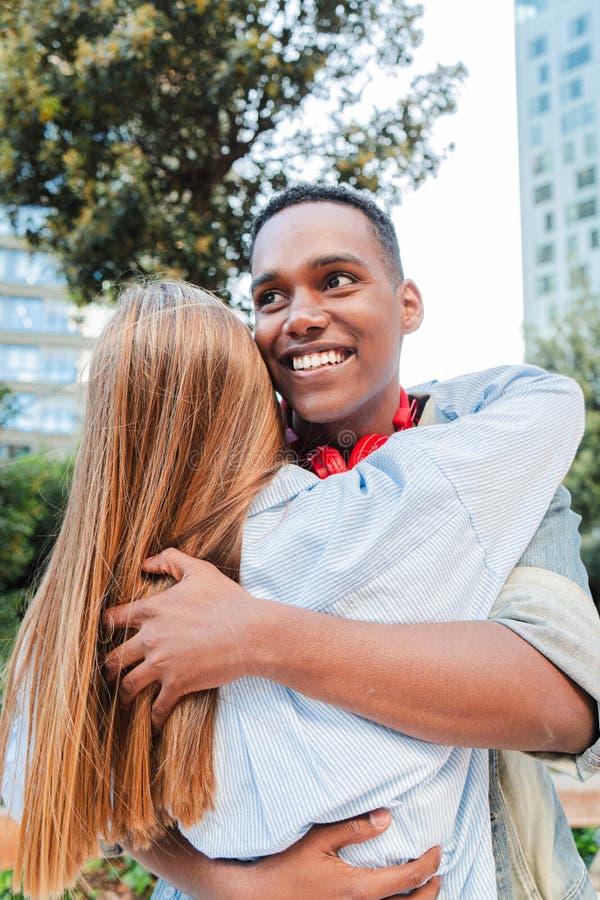 Vertical African American Man Giving A Tender Hug To His Girlfriend