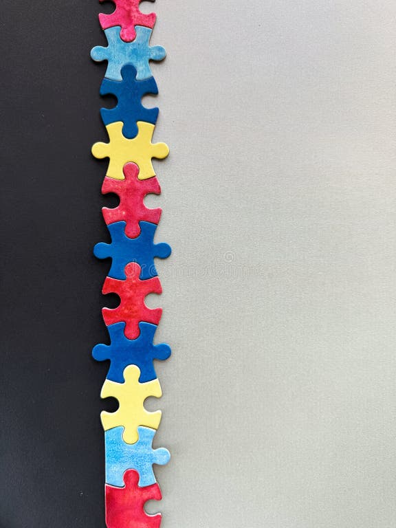 Vertical Arrangement of Colorful Puzzle Pieces on a Black and Gray ...