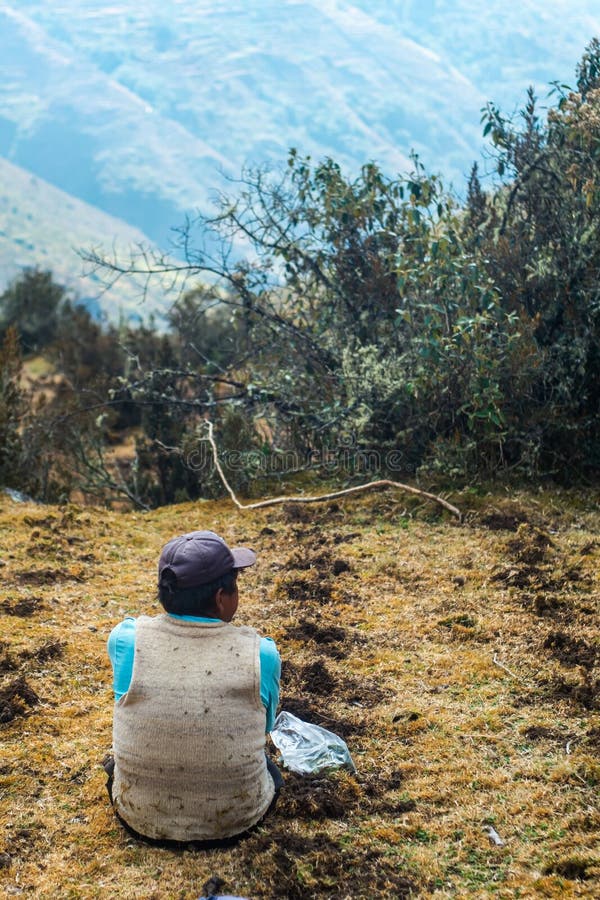 Vertical Back Shot of a Peruvian Farmer Sitting Looking Out Over the ...