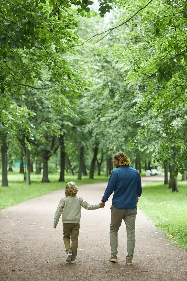 Back View of Father and Son Walking Away on Park Path Stock Photo ...