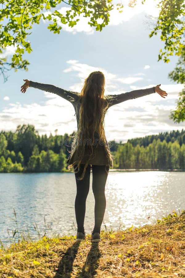 Vertical Back View of a Female Enjoying the Sunlight by the Lake Stock ...