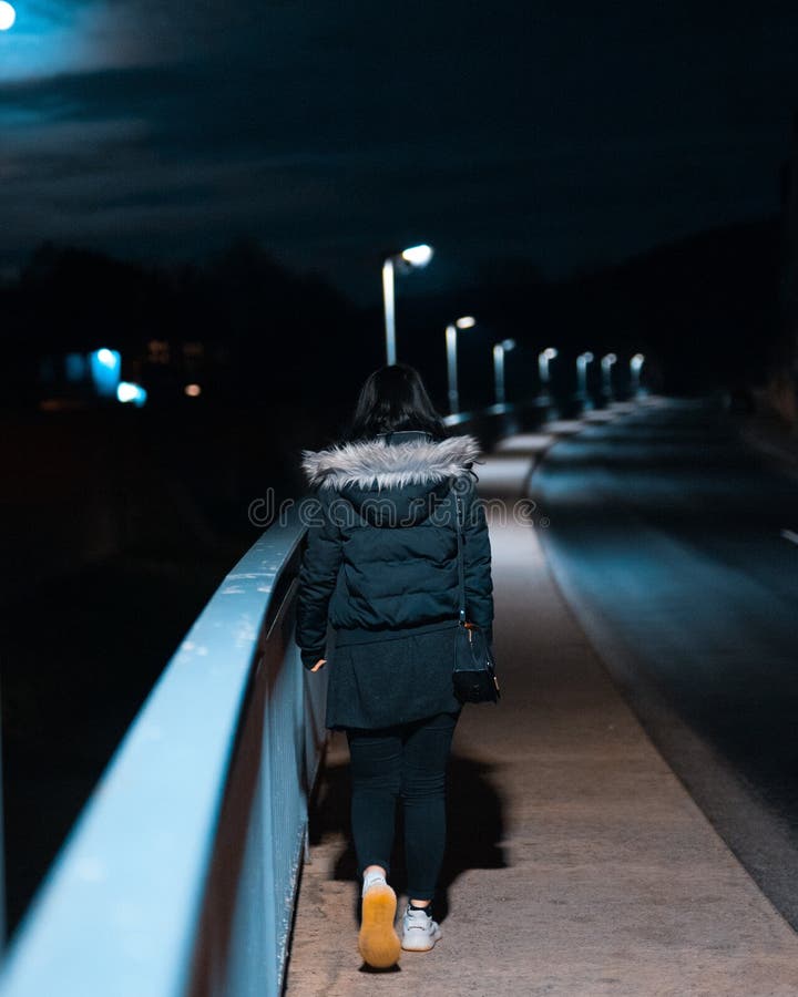 Vertical Back View of a Female Walking through a Bridge at Night Stock ...