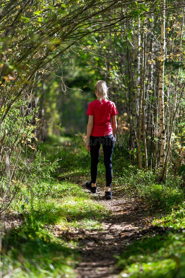Vertical Back View of a Female Walking in a Forest Stock Photo - Image ...
