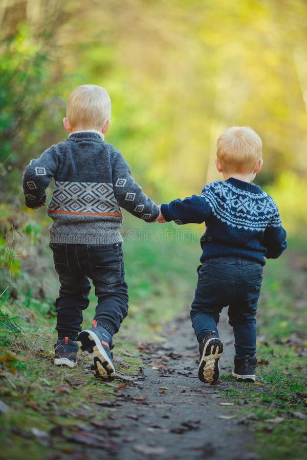 Vertical Back View of Two Kids Walking on a Trail in a Forest Stock ...