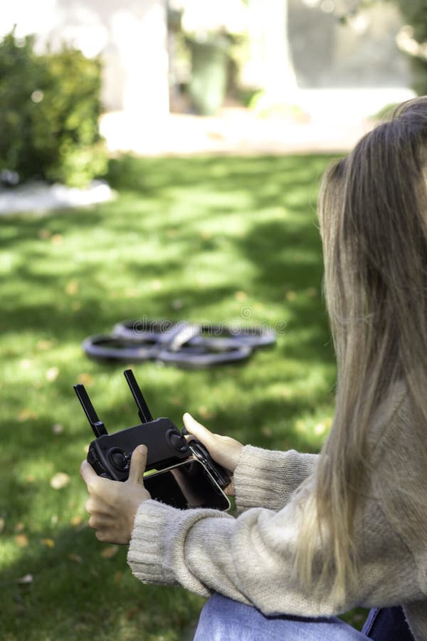 Vertical Back View of Unrecognizable Young Blond Woman Holding a Remote ...