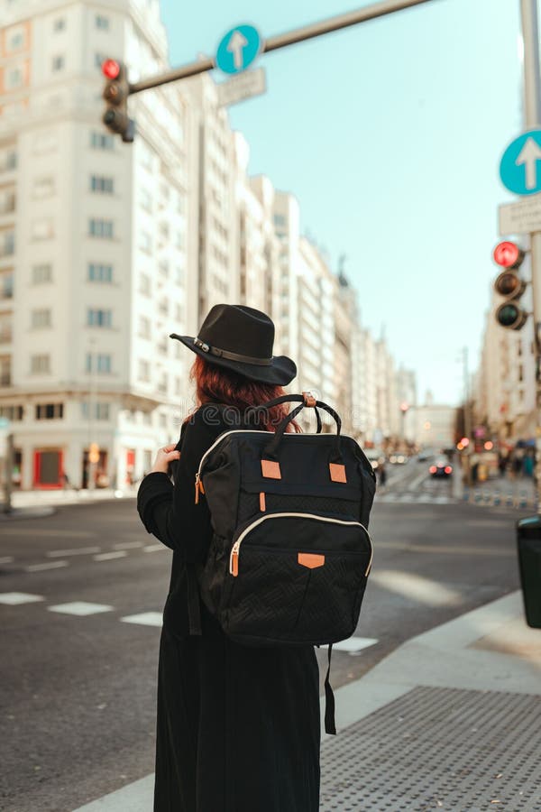 Vertical Back View of a Young Female Wearing Black Coat and Backpack on ...
