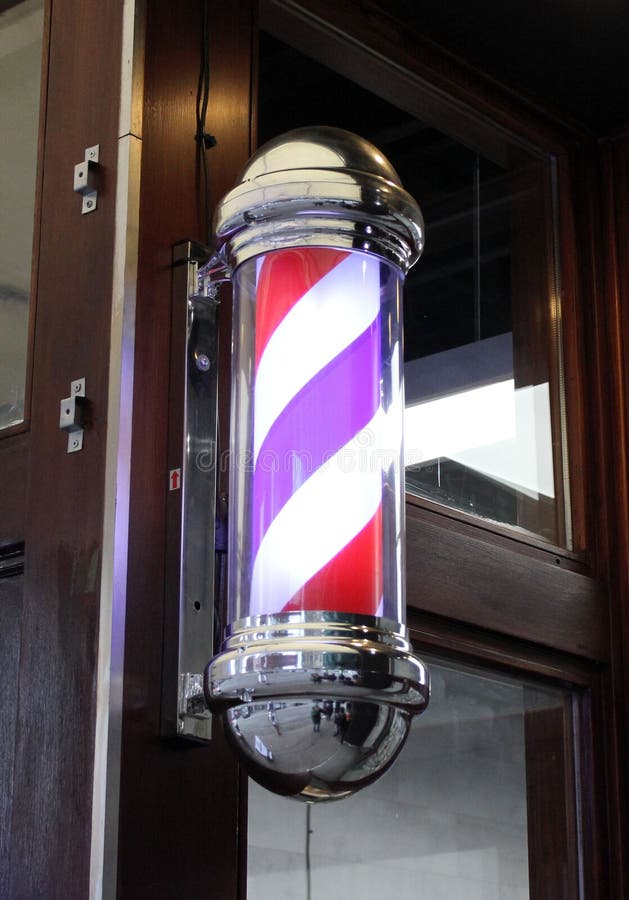 Vertical of a Barber Pole on the Wall Stock Image - Image of wall ...