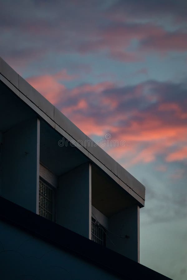 Vertical of a Beautiful Sunset Over a Building. Stock Photo - Image of ...