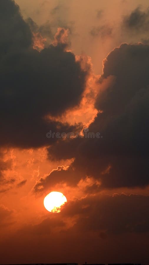 Vertical of a Beautiful Sunset with a Round Sun Stock Image - Image of ...