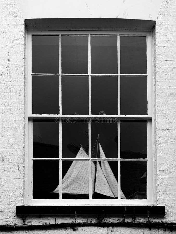 Vertical Black and White Shot of a Window with a Sailing Seen Inside ...