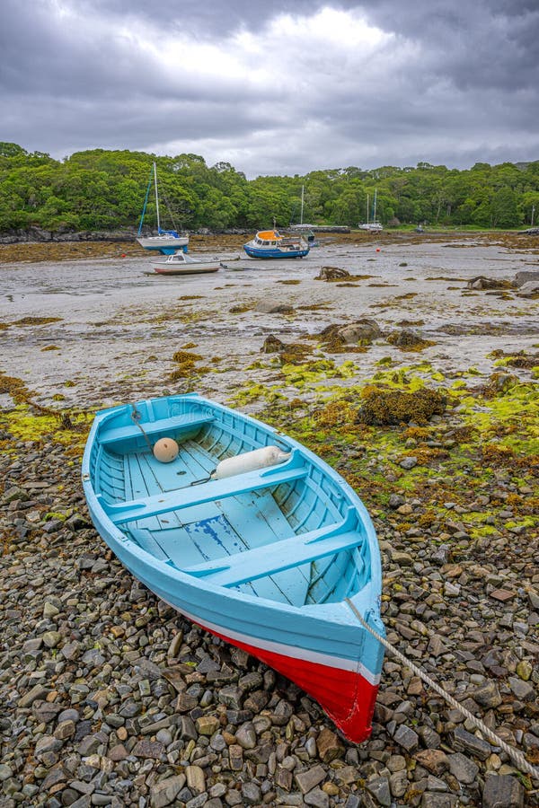 Vertical of a Blue Boat at the Shore of the Lake. Stock Photo - Image ...