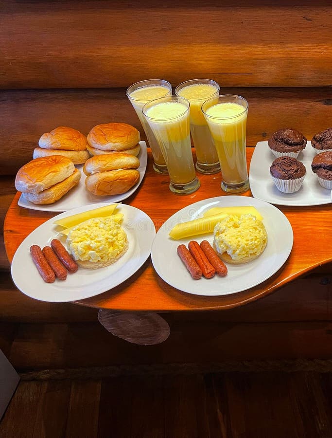 Vertical of a Breakfast Table with Pineapple Juice, Buns, Sausages ...