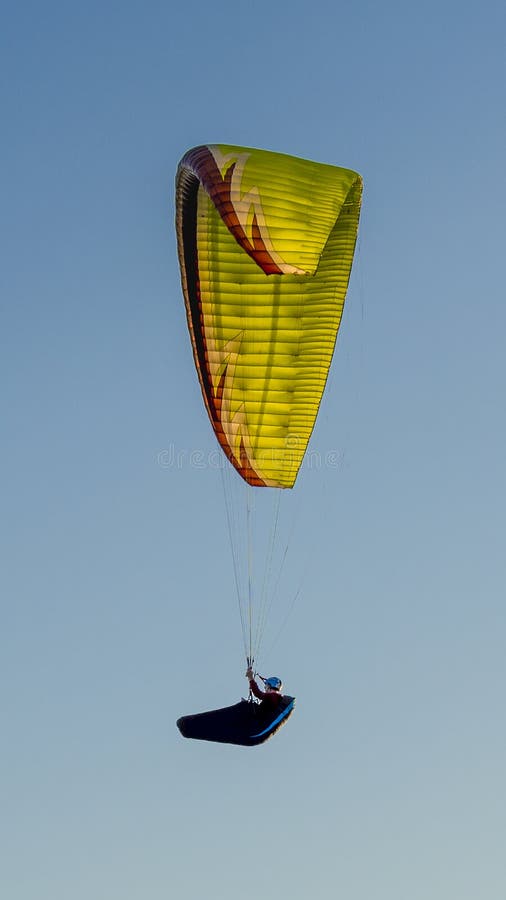 Vertical Capture of a Lone Paraglider with a Bright Yellow Canopy ...