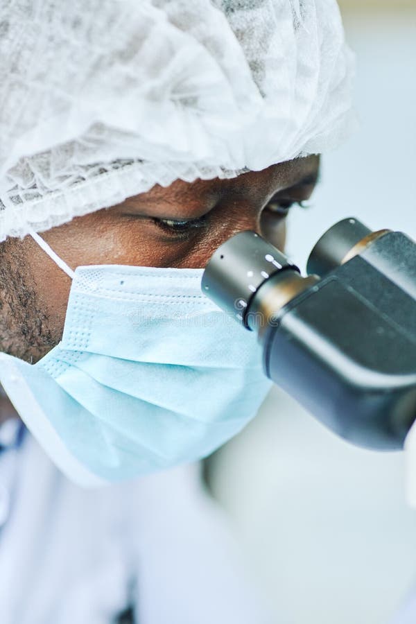 Male African American Scientist Looking in Microscope Working in ...